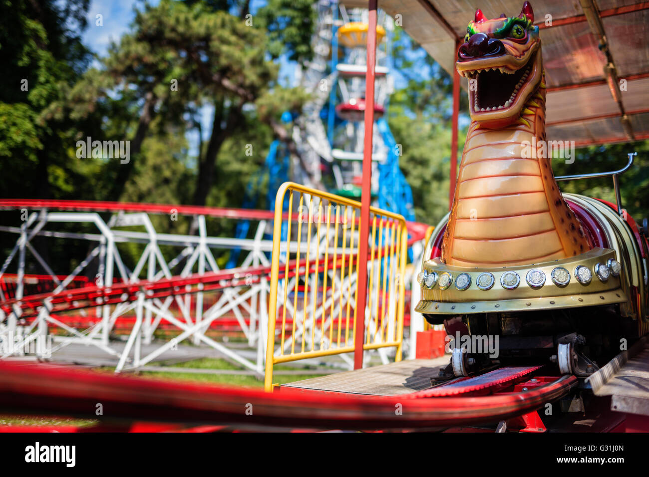 Rollercoaster on rails at Amusement park. Loop rides Stock Photo - Alamy
