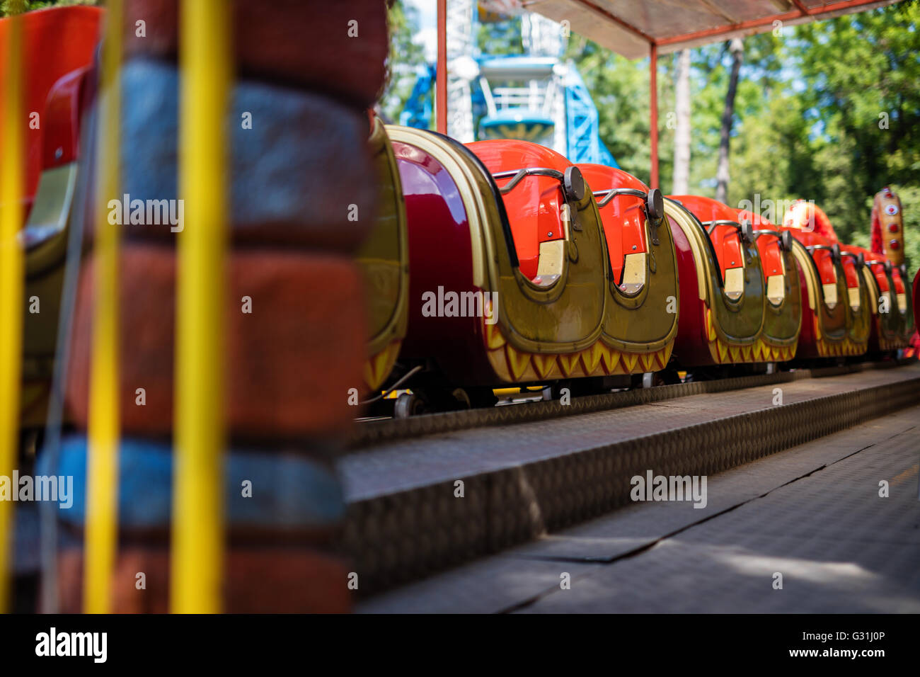 Rollercoaster on rails at Amusement park. Loop rides Stock Photo - Alamy