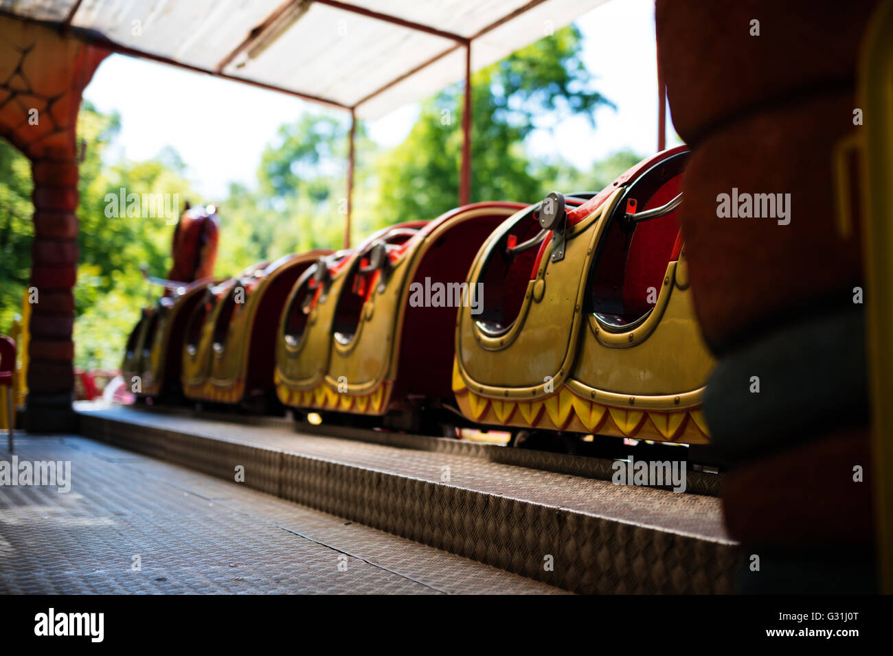 Rollercoaster on rails at Amusement park. Loop rides Stock Photo - Alamy