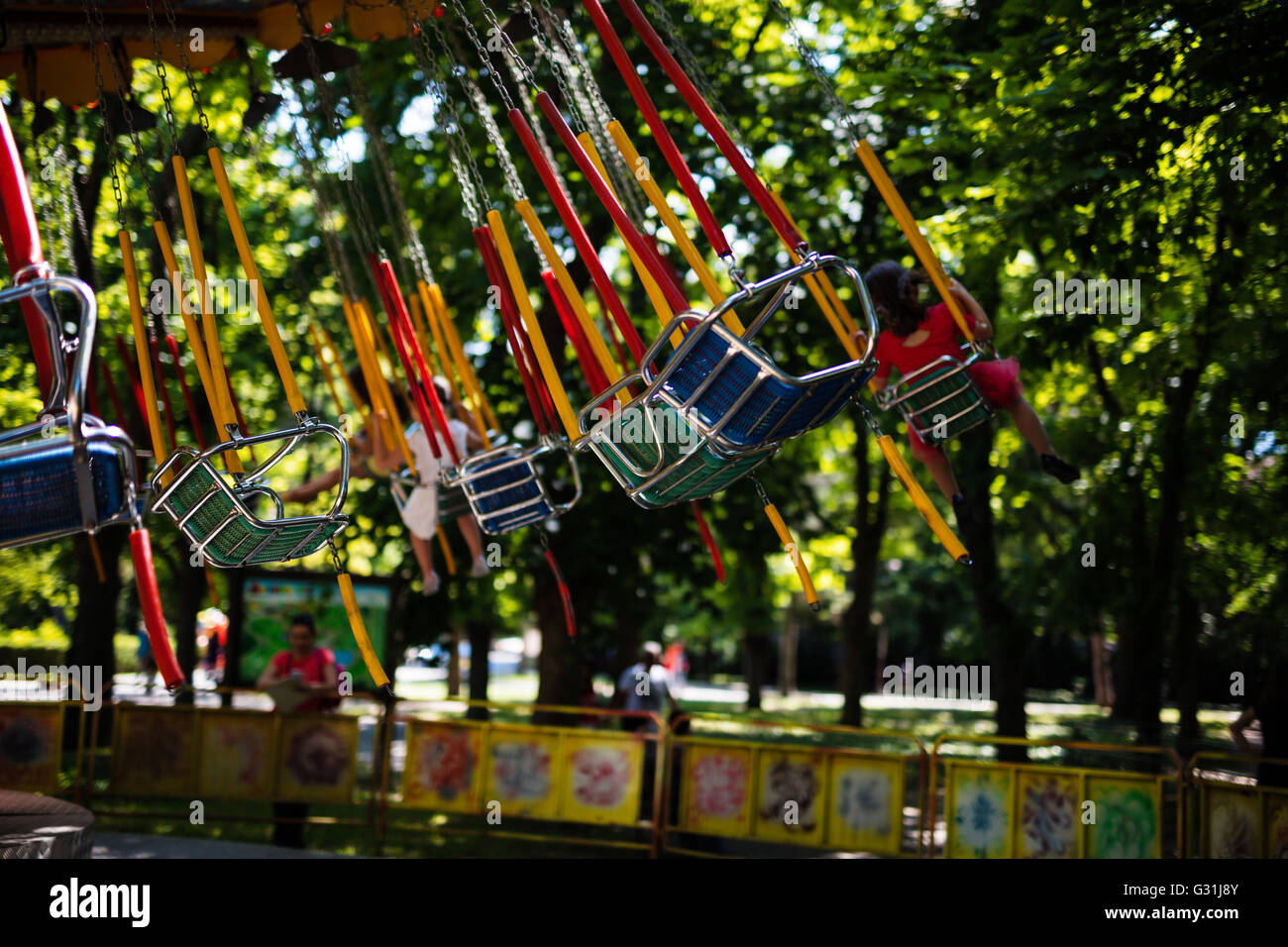Swing seat carousel exciting ride at amusement park Stock Photo - Alamy