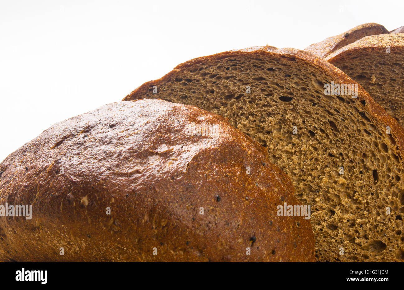 Sliced dark bread with crumbs on wood board Stock Photo - Alamy