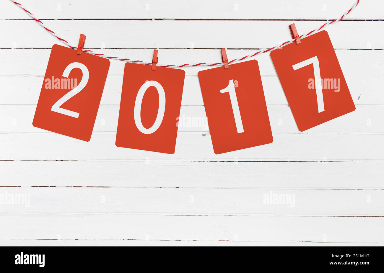 Paper or photo frames with 2017 figures hanging on the red striped rope ...
