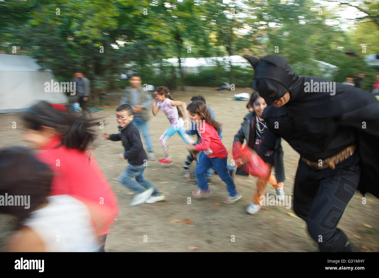 Berlin, Germany, Oemer Aslan in Batman Costume plays with children of ...