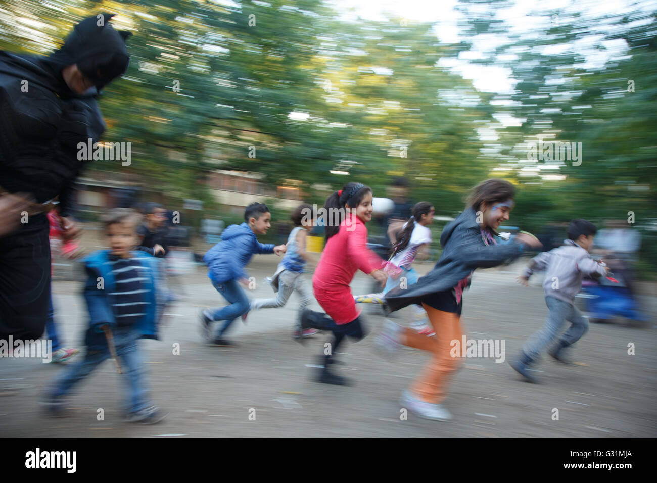 Berlin, Germany, Oemer Aslan in Batman Costume plays with children of ...