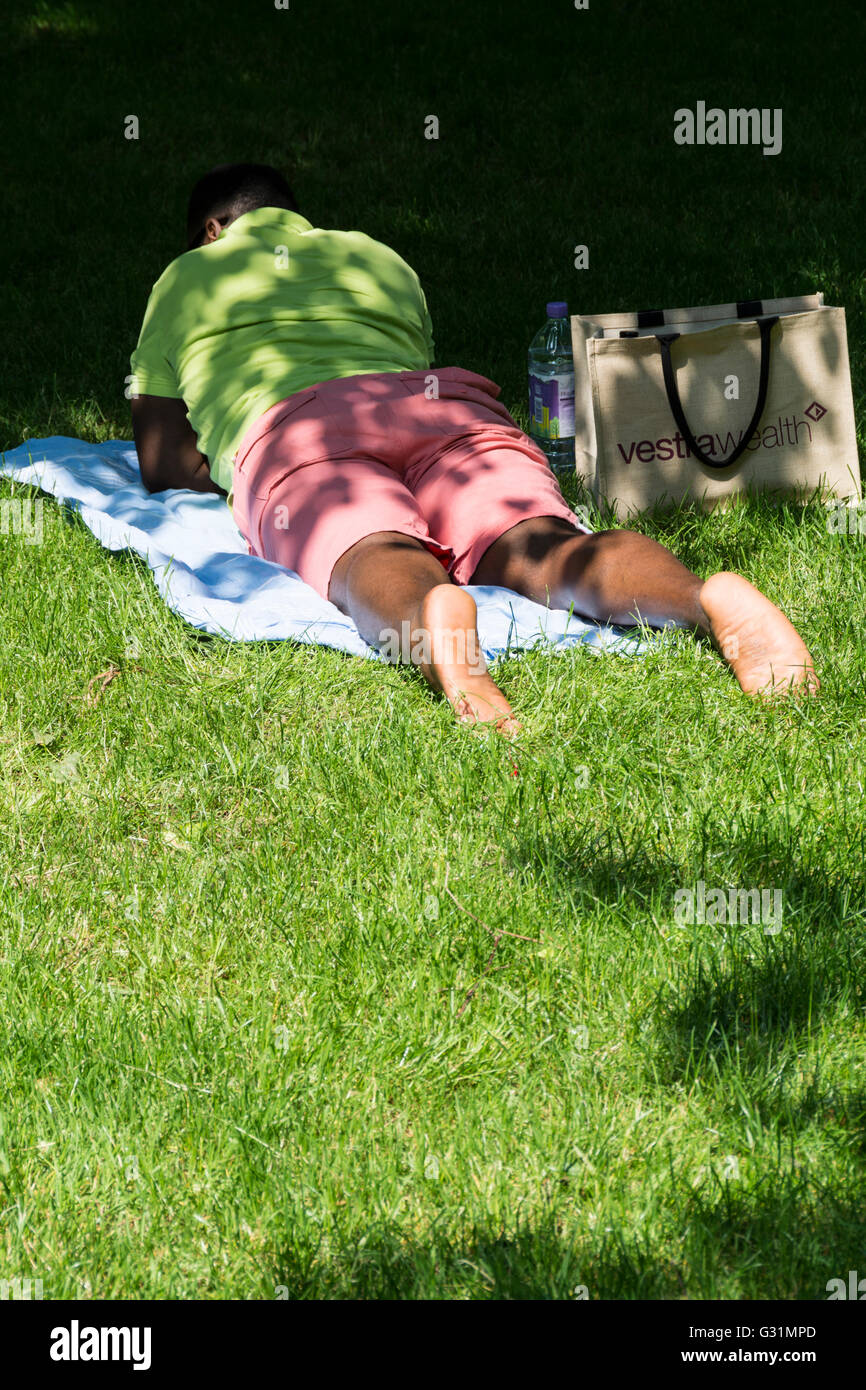 A man sunbathing in Hyde Park, City of Westminster, London, England ...