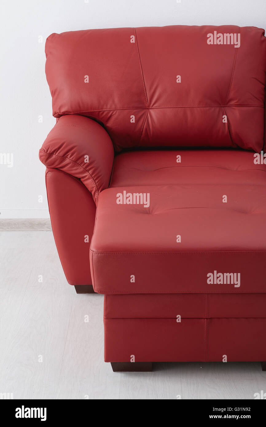 Red leather sofa isolated against the wall Stock Photo - Alamy