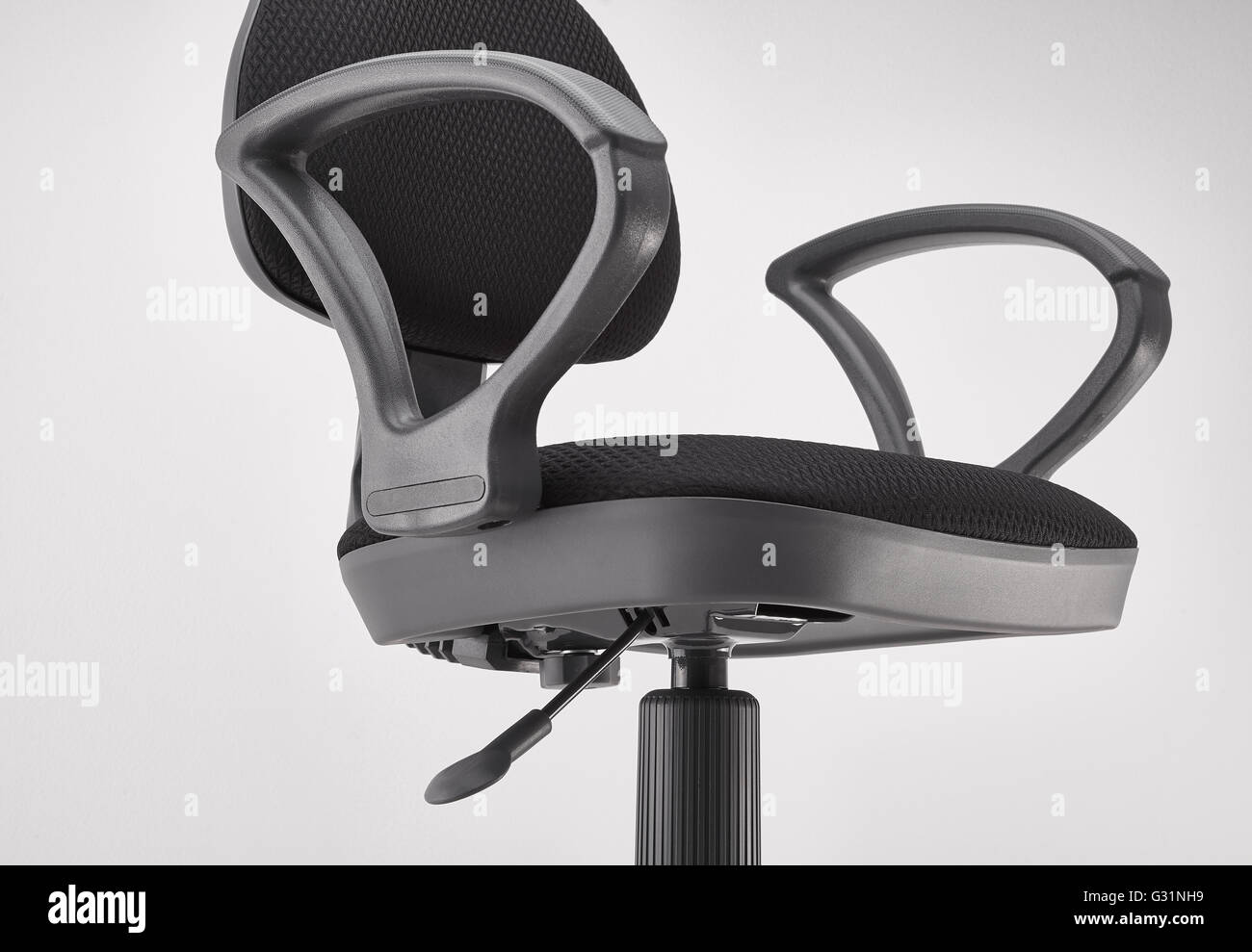 Close up side view of black office swivel chair on wheels with a ...