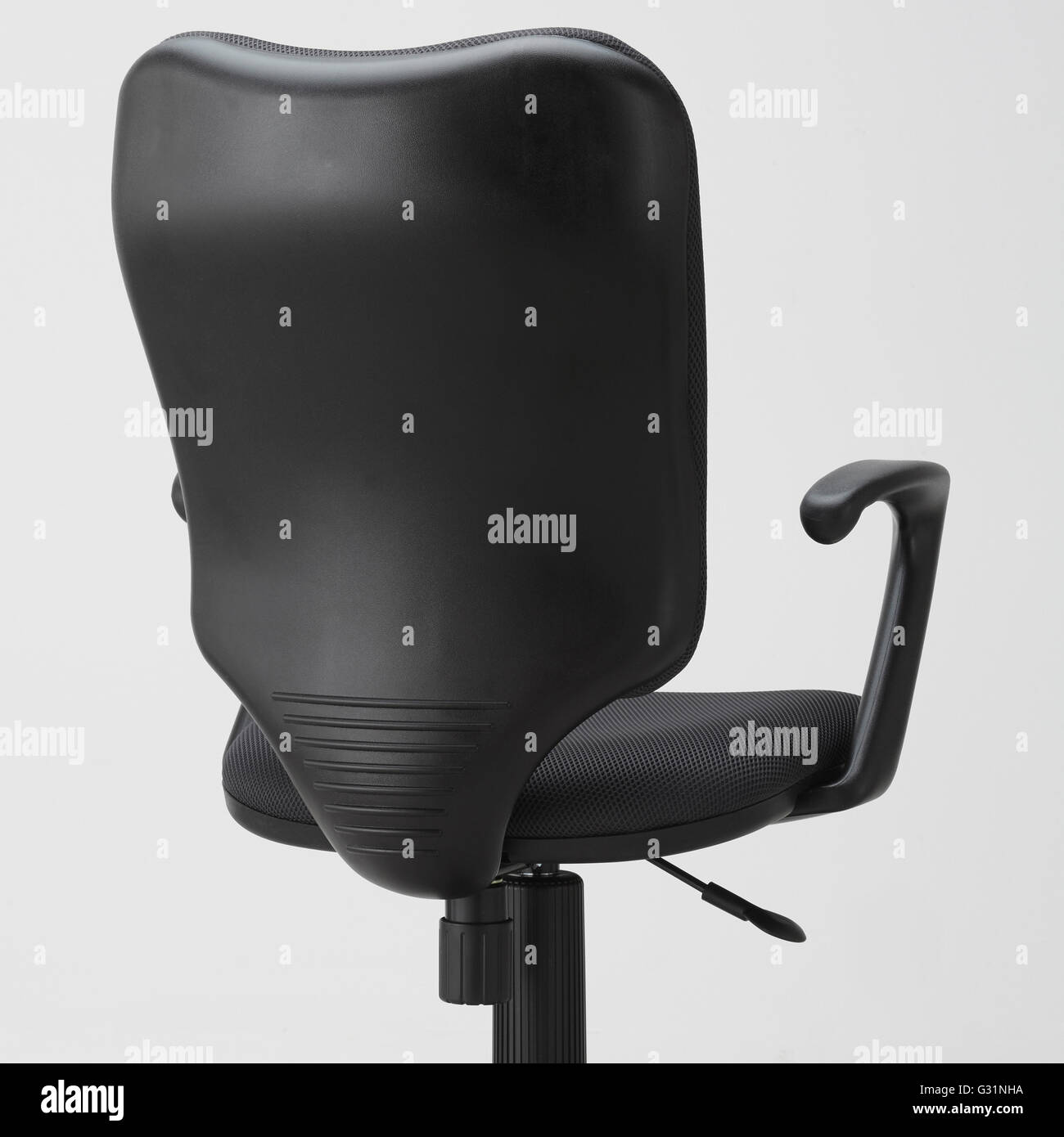 Rear view of black office swivel chair on wheels with a mechanism for ...