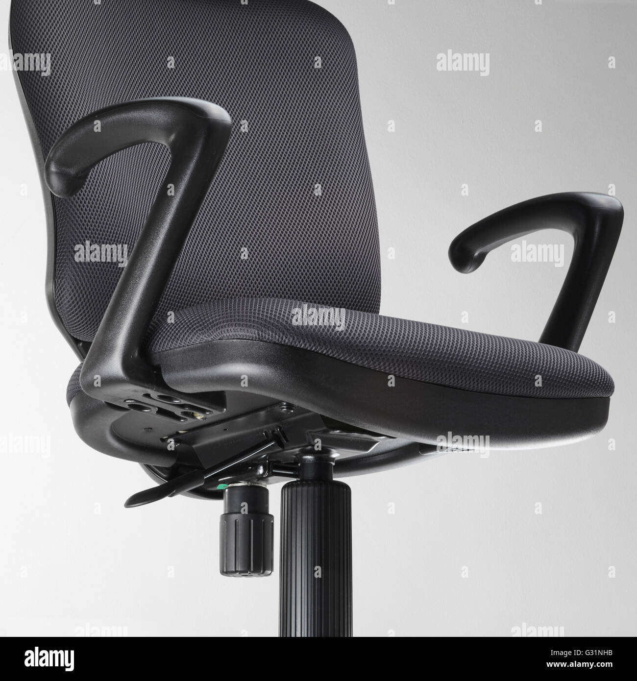 Close up side view of black office swivel chair on wheels with a ...