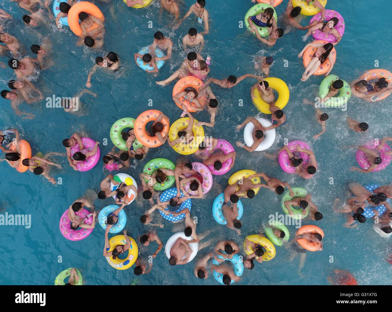 Chongqing, China. 6th June, 2016. Tourists play in a swimming pool at a ...