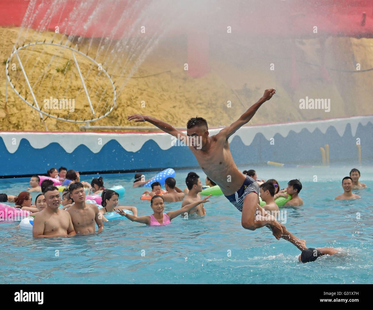 Chongqing, China. 6th June, 2016. Tourists play in a swimming pool at a ...