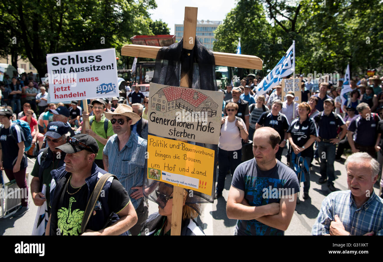 Munich, Germany. 06th June, 2016. A demonstrator holds up a cross that ...