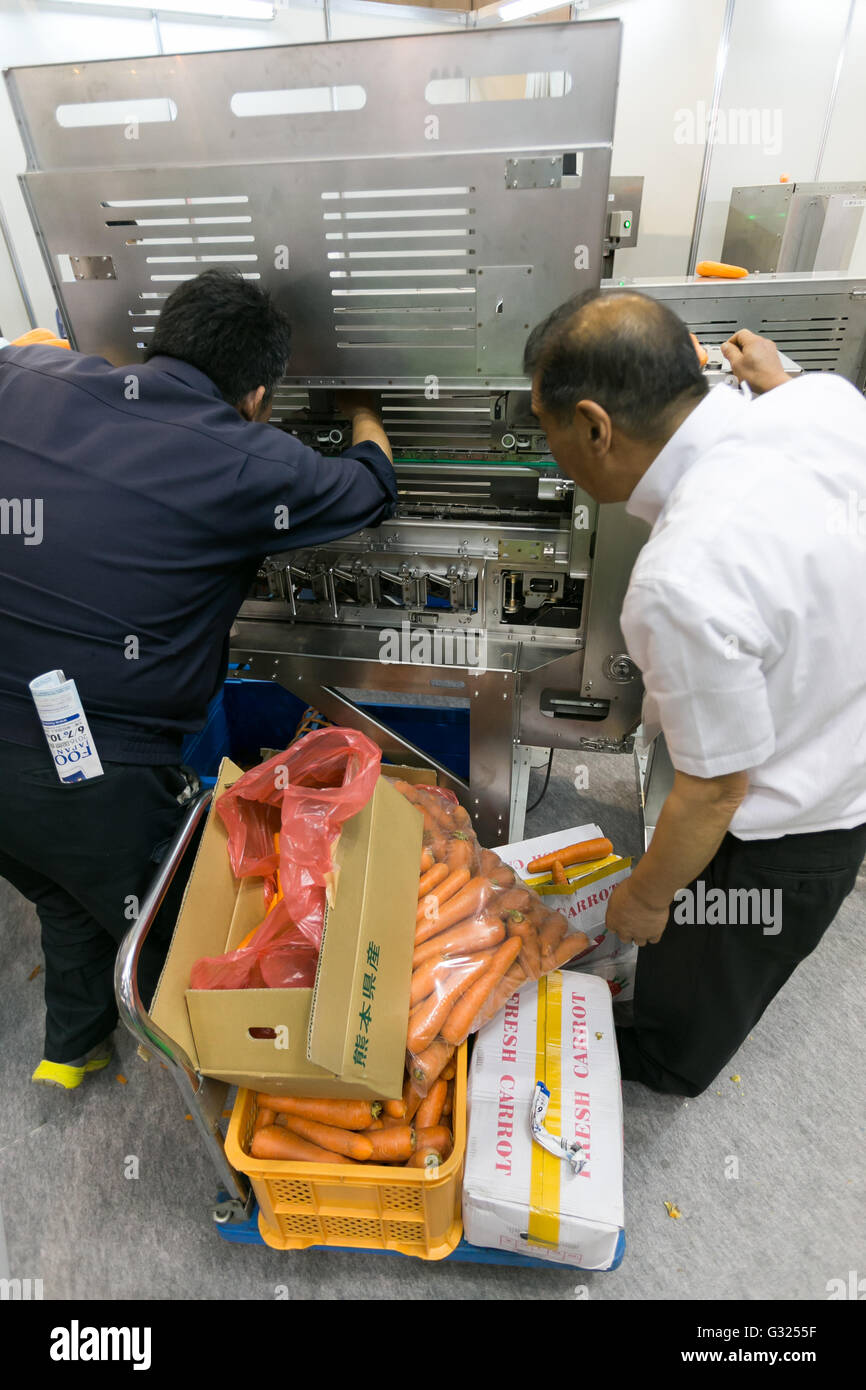 Visitors look at the latest technology products for food processing at ...