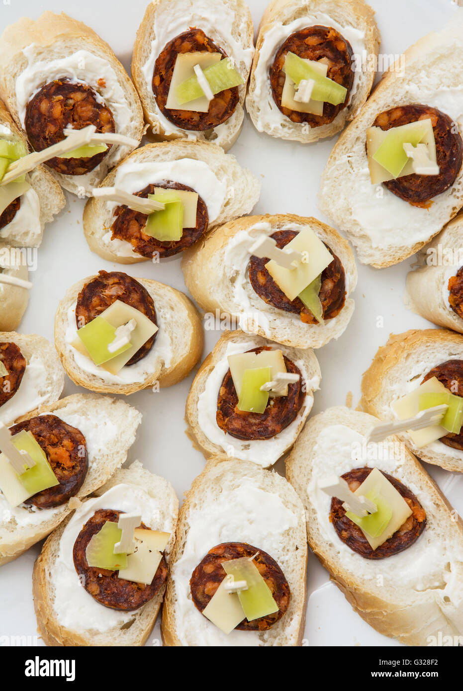 Tasty canapes with butter, sausage, cheese and paprika. Food theme ...