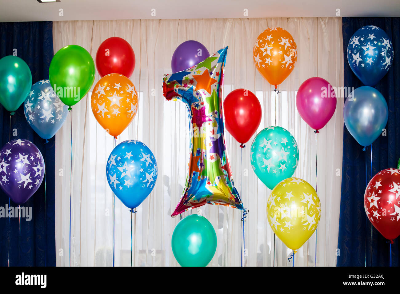 Birthday party, one year balloon sign and many colorful balloons Stock ...