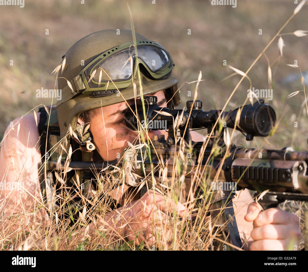 young a soldier in the uniform with weapon Stock Photo - Alamy