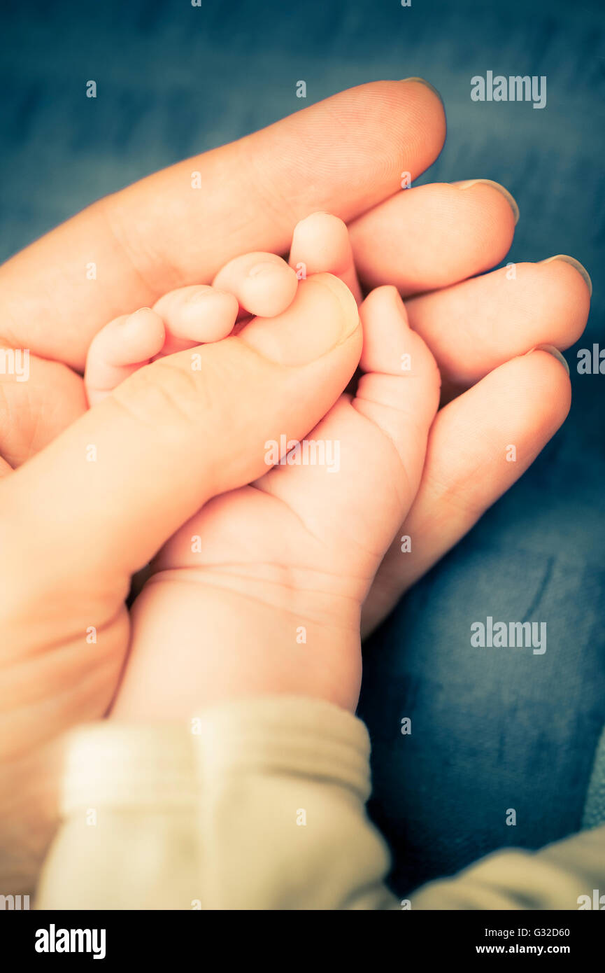 Hand of mother holding hand of baby Stock Photo - Alamy