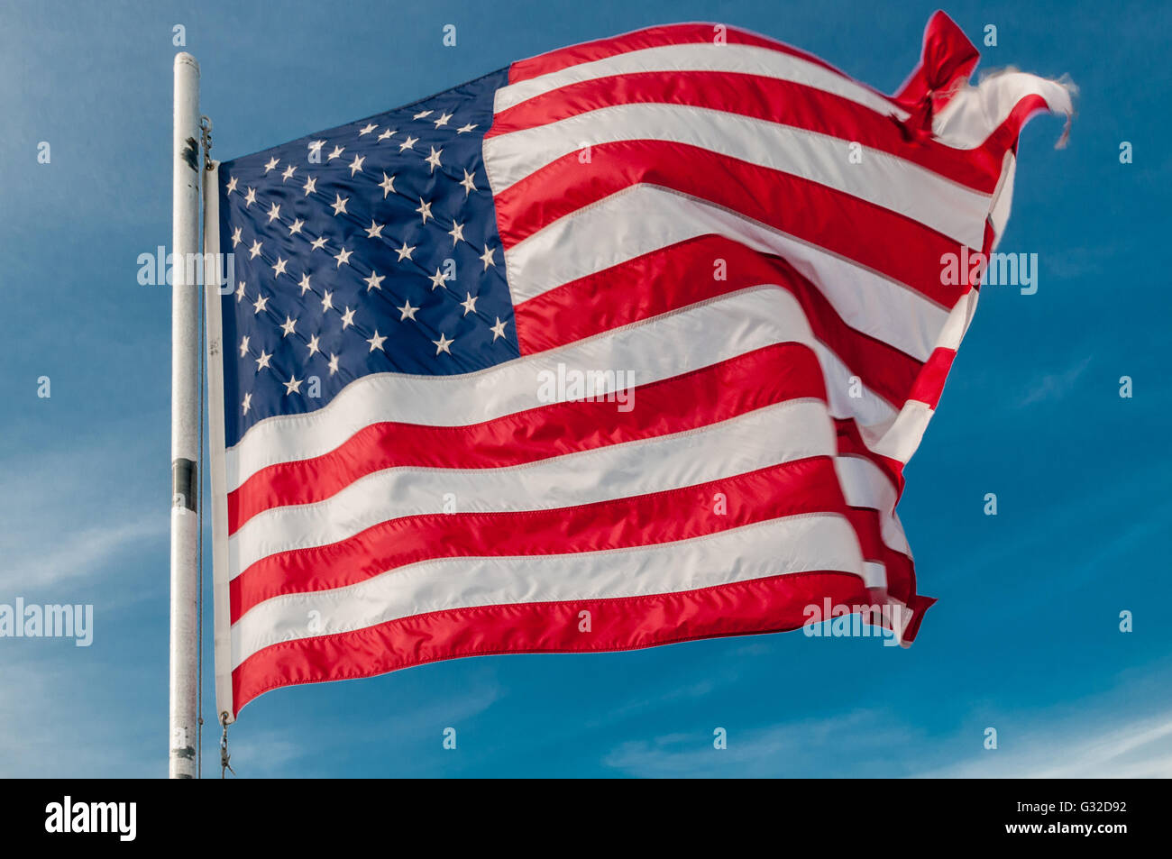 American flag against bright blue sky Stock Photo - Alamy