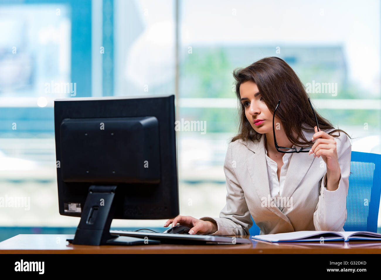 Businesswoman sitting at the office desk Stock Photo - Alamy