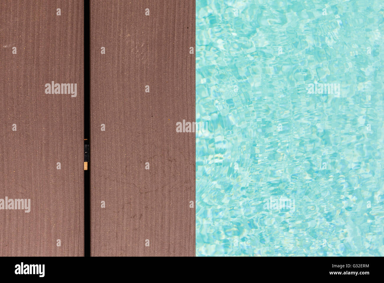 wooden planks at the pool side with vibrant pool water Stock Photo - Alamy