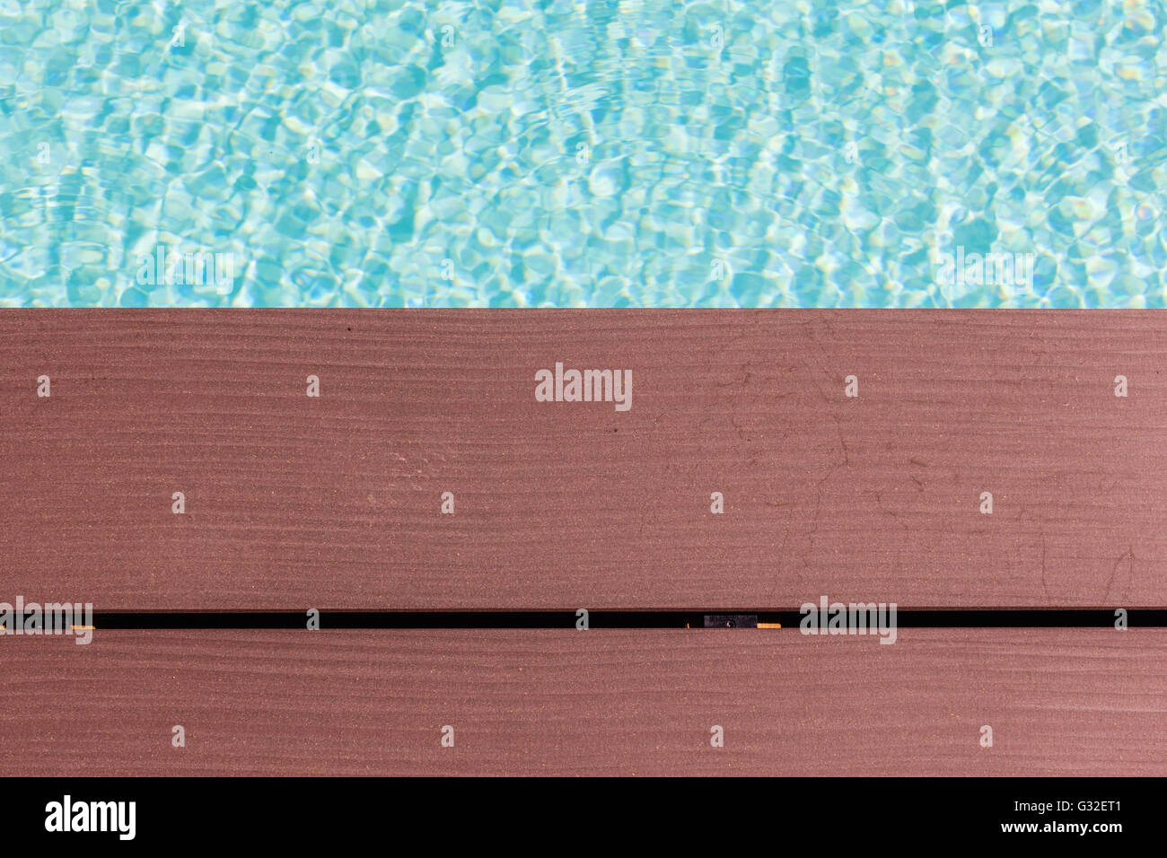 wooden planks at the pool side with vibrant pool water Stock Photo - Alamy