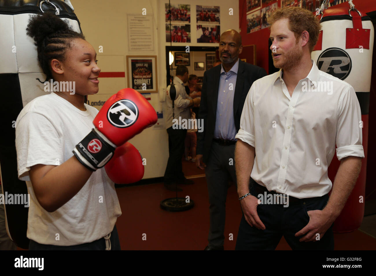 Prince Harry (right) speaks with a young boxer during a visit to the ...