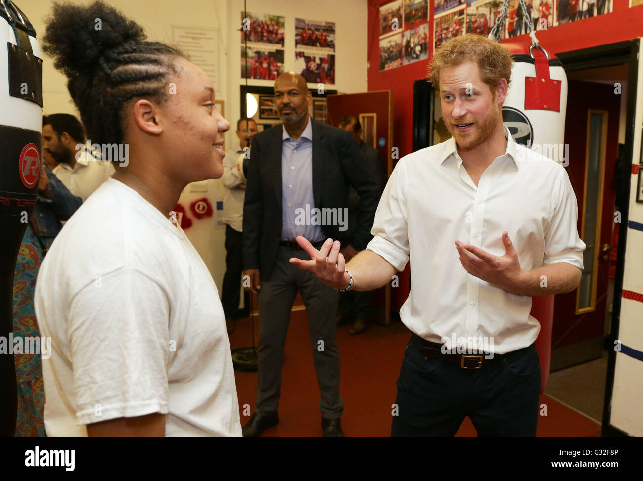 Prince Harry (right) speaks with a young boxer during a visit to the ...