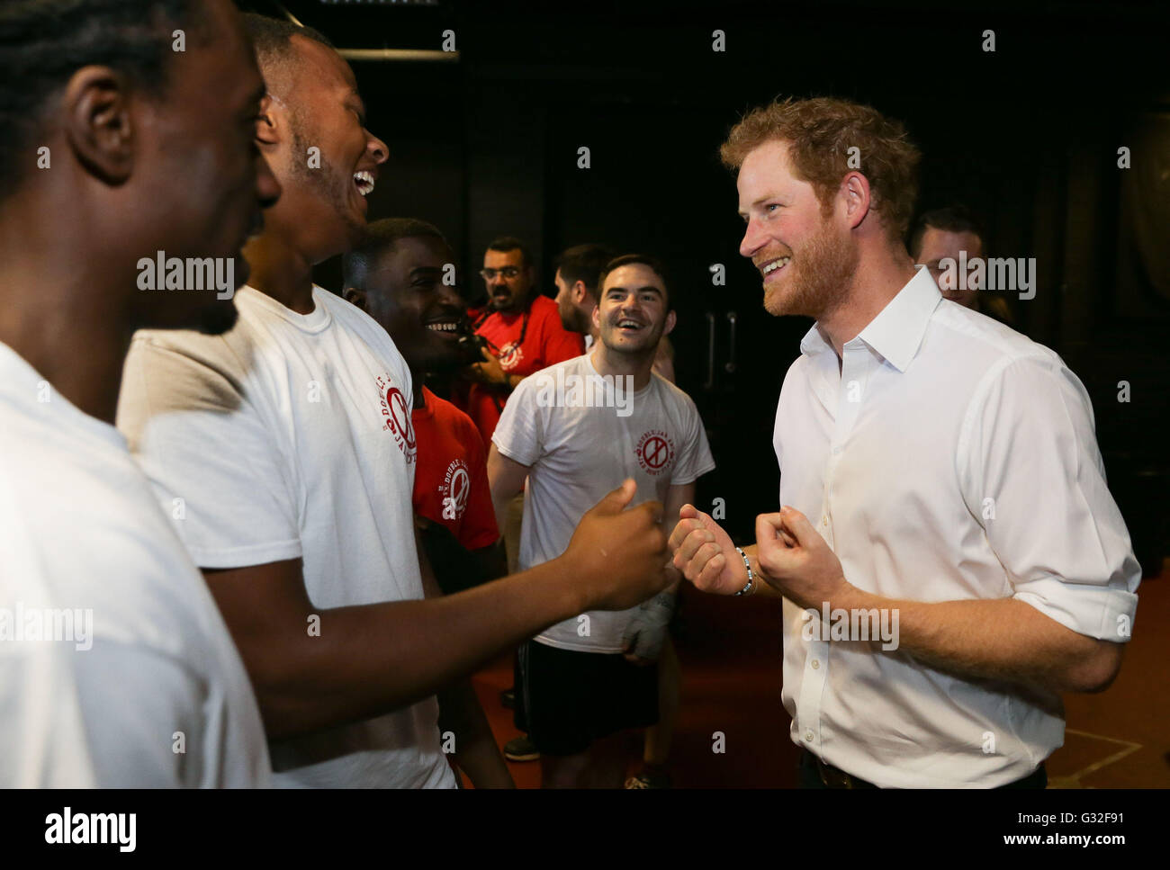 Prince Harry (right) meets young boxers during a visit to the Double ...