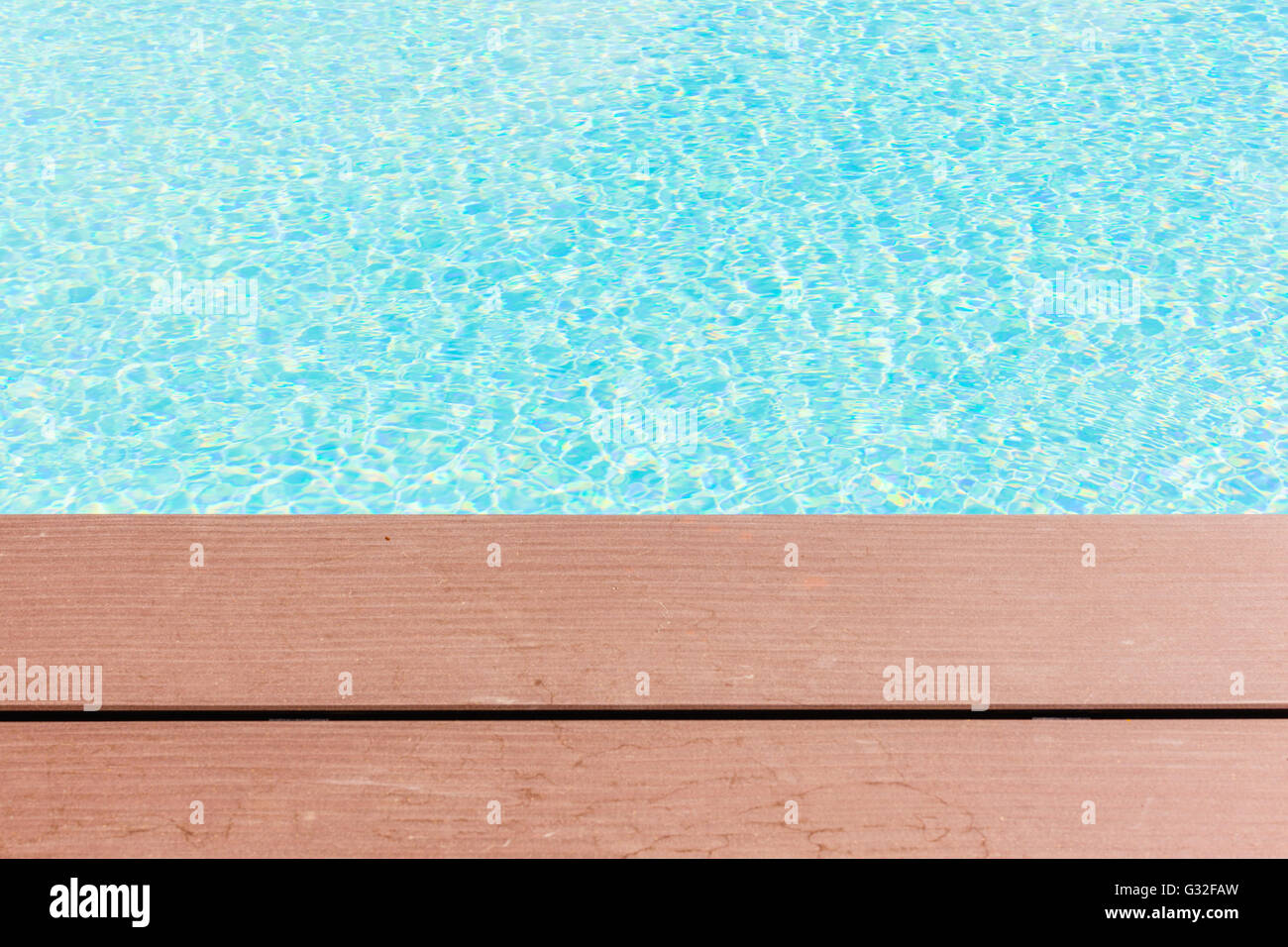 wooden planks at the pool side with vibrant pool water Stock Photo - Alamy