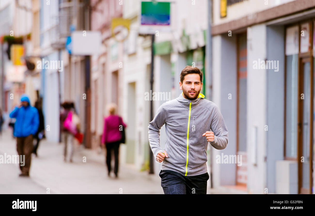 Young hipster man running in town, main street Stock Photo - Alamy