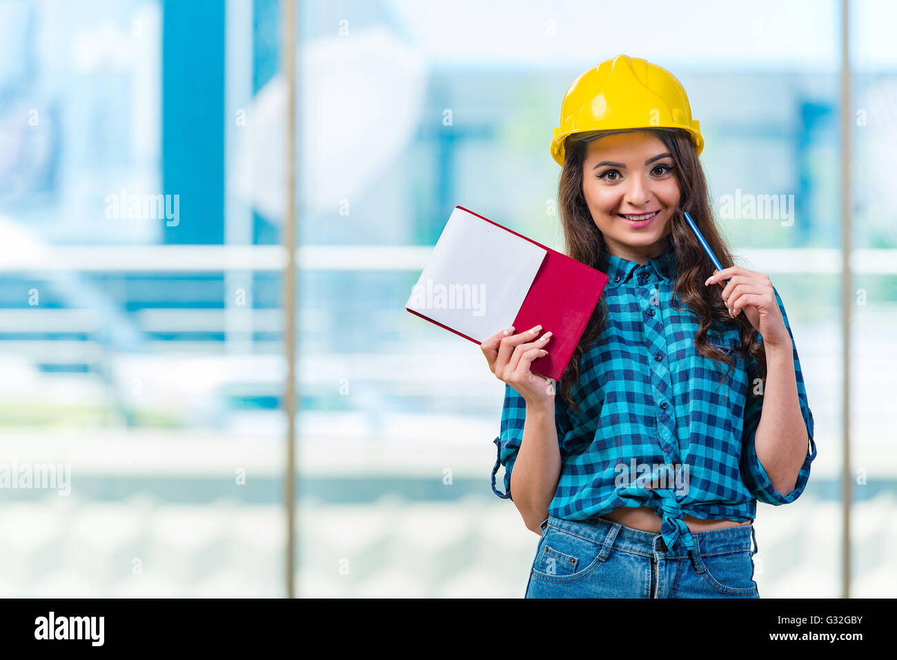 Woman builder taking notes at construction site Stock Photo - Alamy