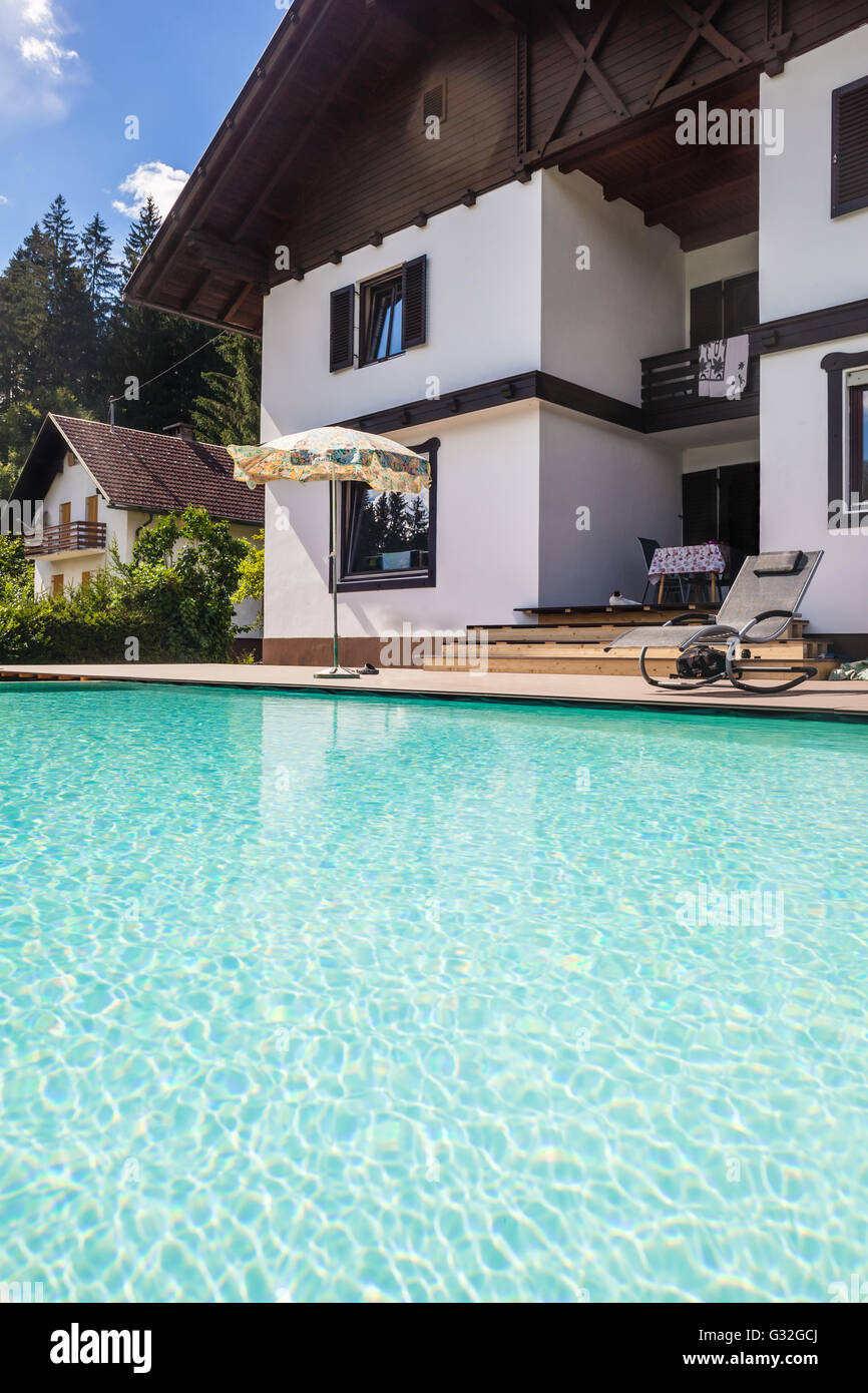 a big austrian villa with a big vibrant pool in the summer Stock Photo ...