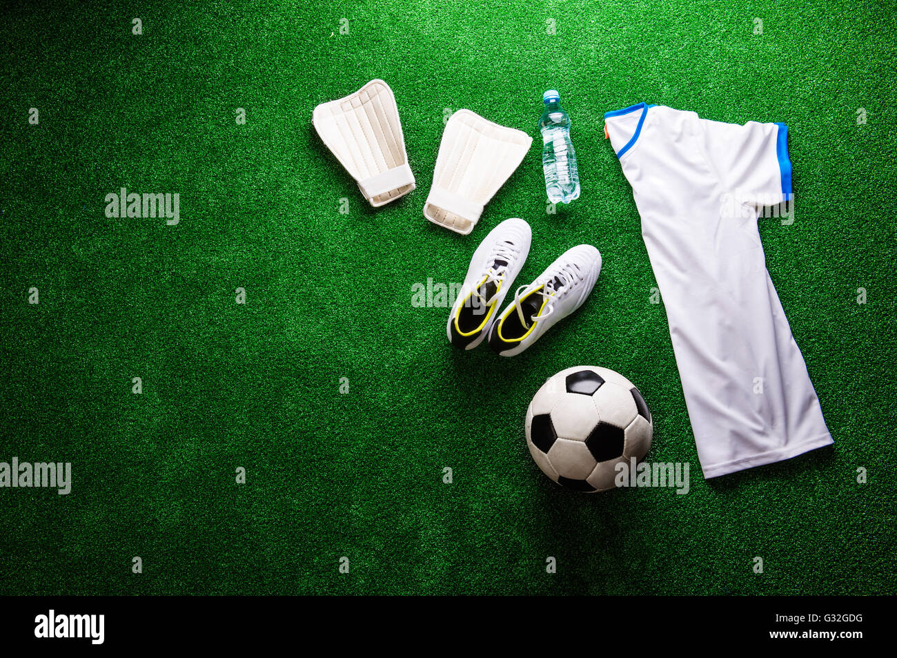 Soccer ball,cleats and various football stuff against artificial Stock ...