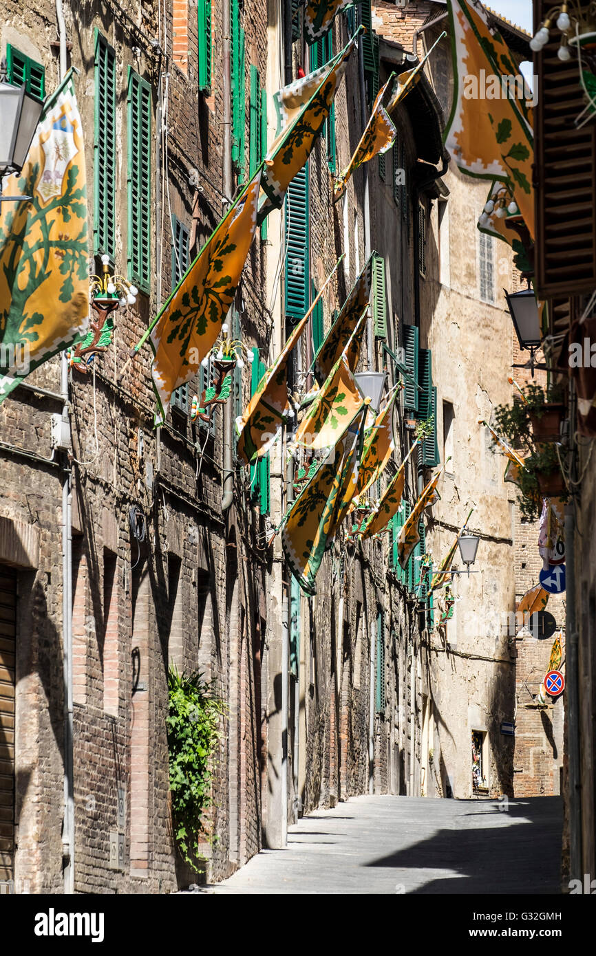 Narrow streets flags of Siena town. Tuscany, Italy Stock Photo - Alamy