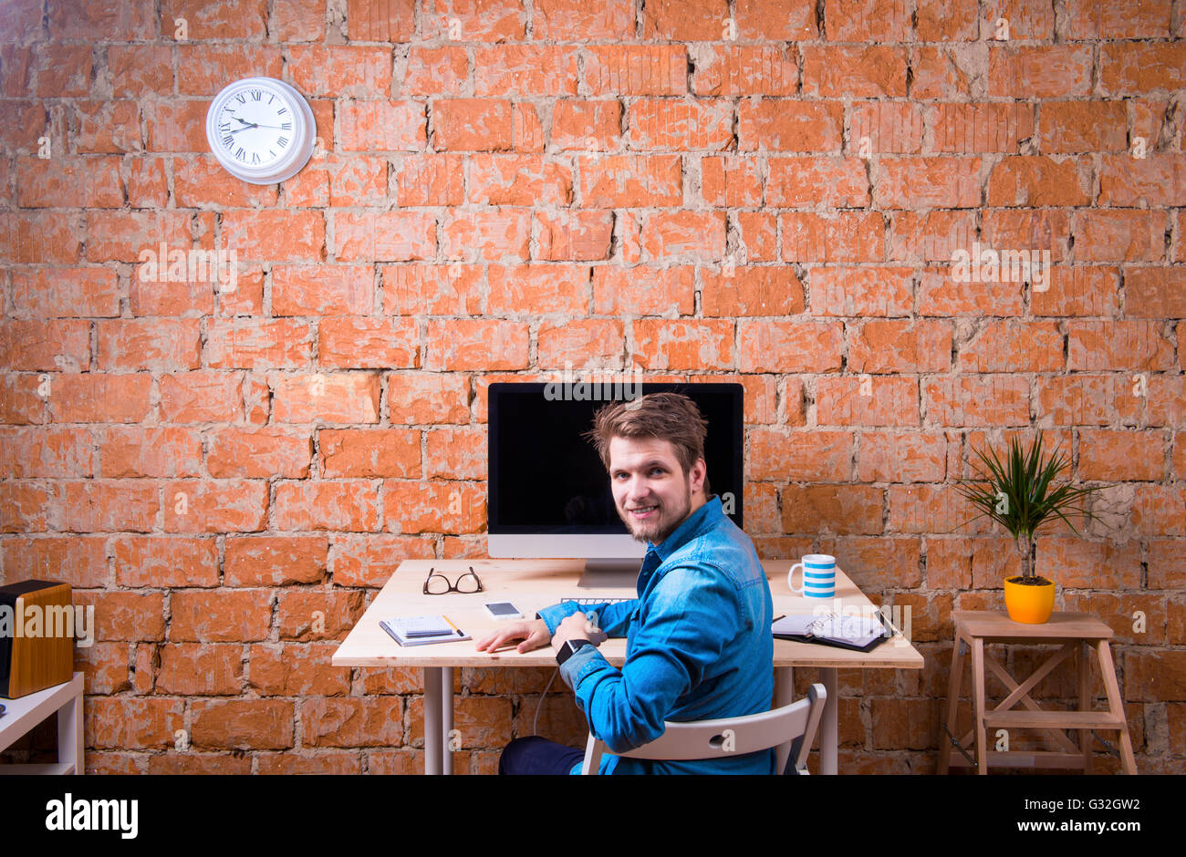 Business person sitting at office desk wearing smart watch Stock Photo ...