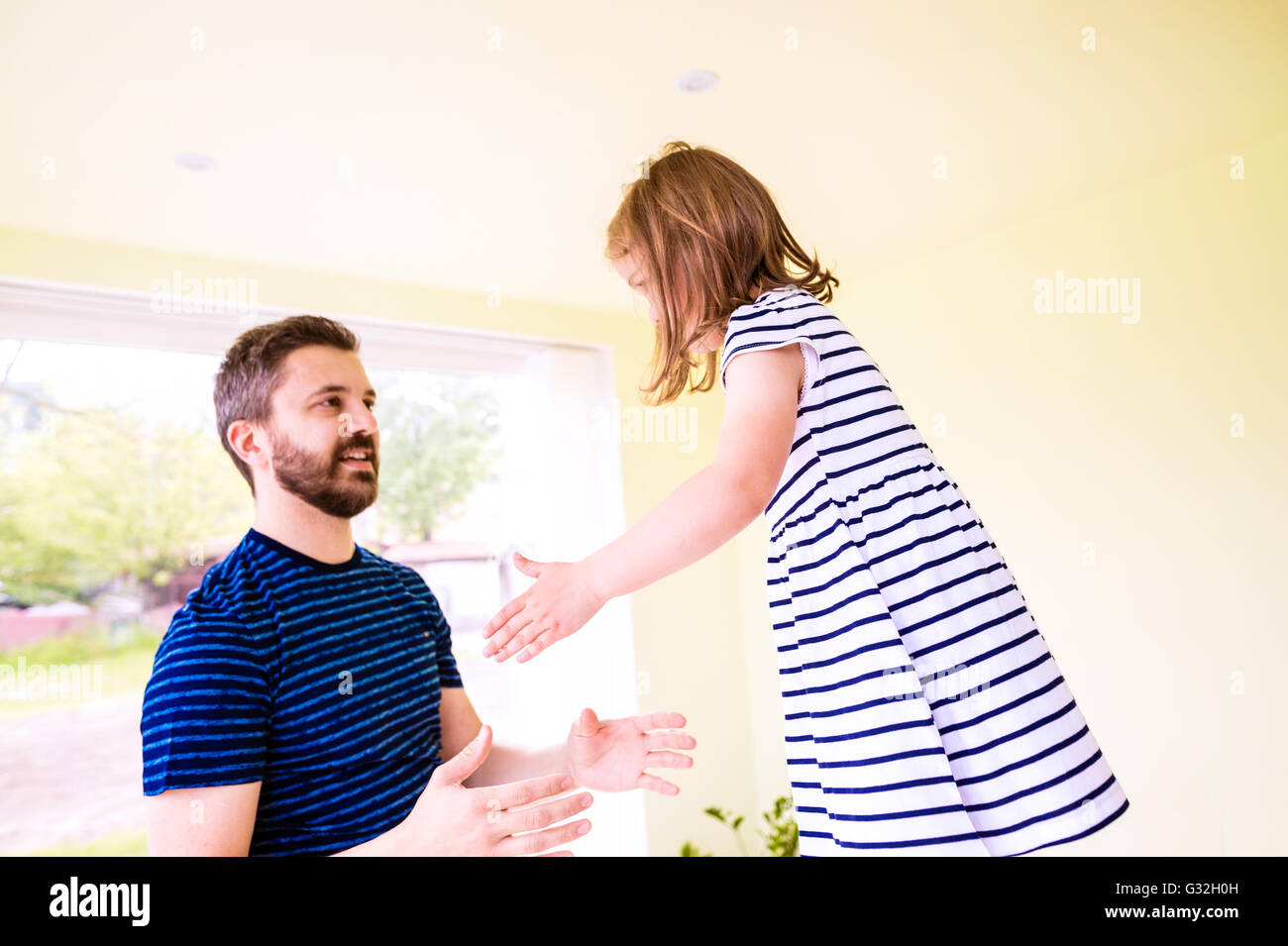 Child jumping fathers arms hi-res stock photography and images - Alamy