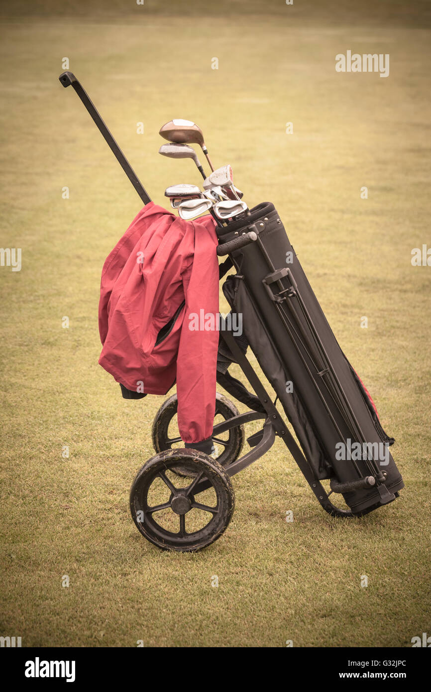 a wheeled golf bag full of golf clubs of a vibrant golf course Stock ...
