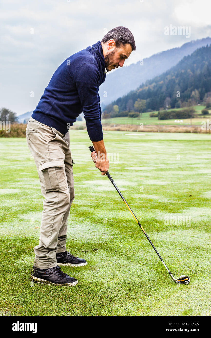 a golf player making a swing on a vibrant beautiful golf course Stock ...