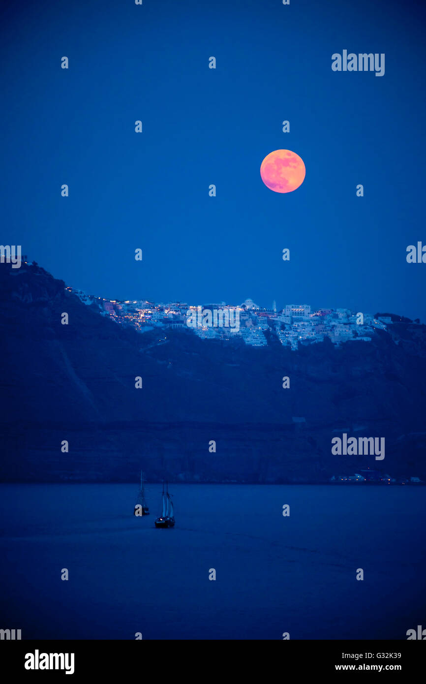 Full moon rising over the island of Santorini in the Cyclades, Greece ...