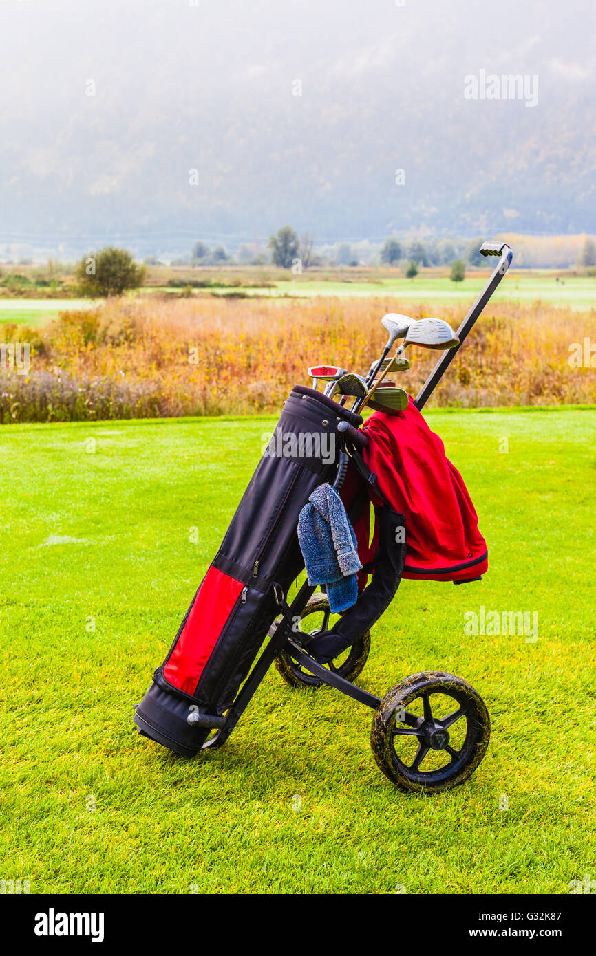 a wheeled golf bag full of golf clubs of a vibrant golf course Stock ...