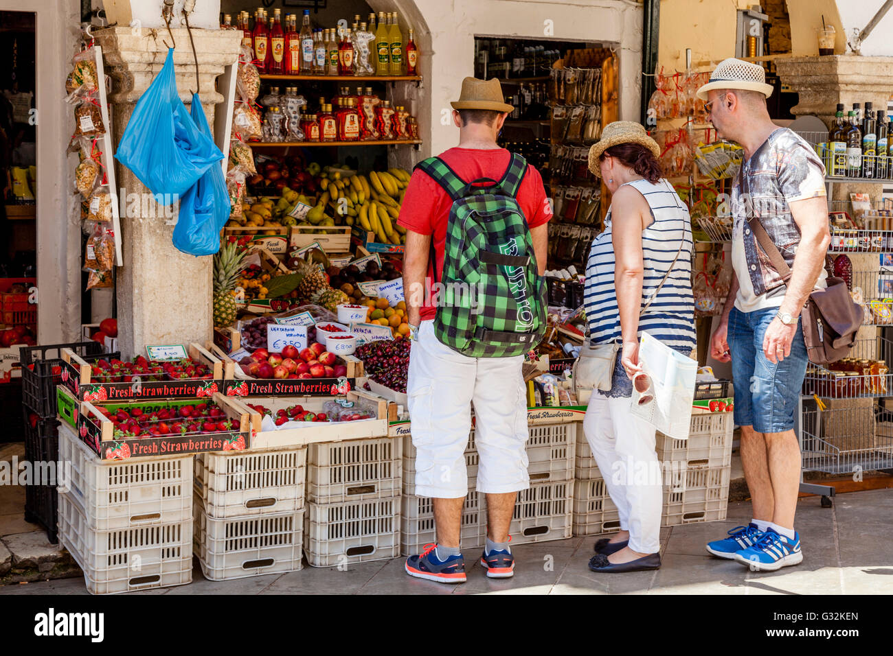 Tourists Buying Fruit From A Shop In Corfu Old Town, Corfu, Greece ...
