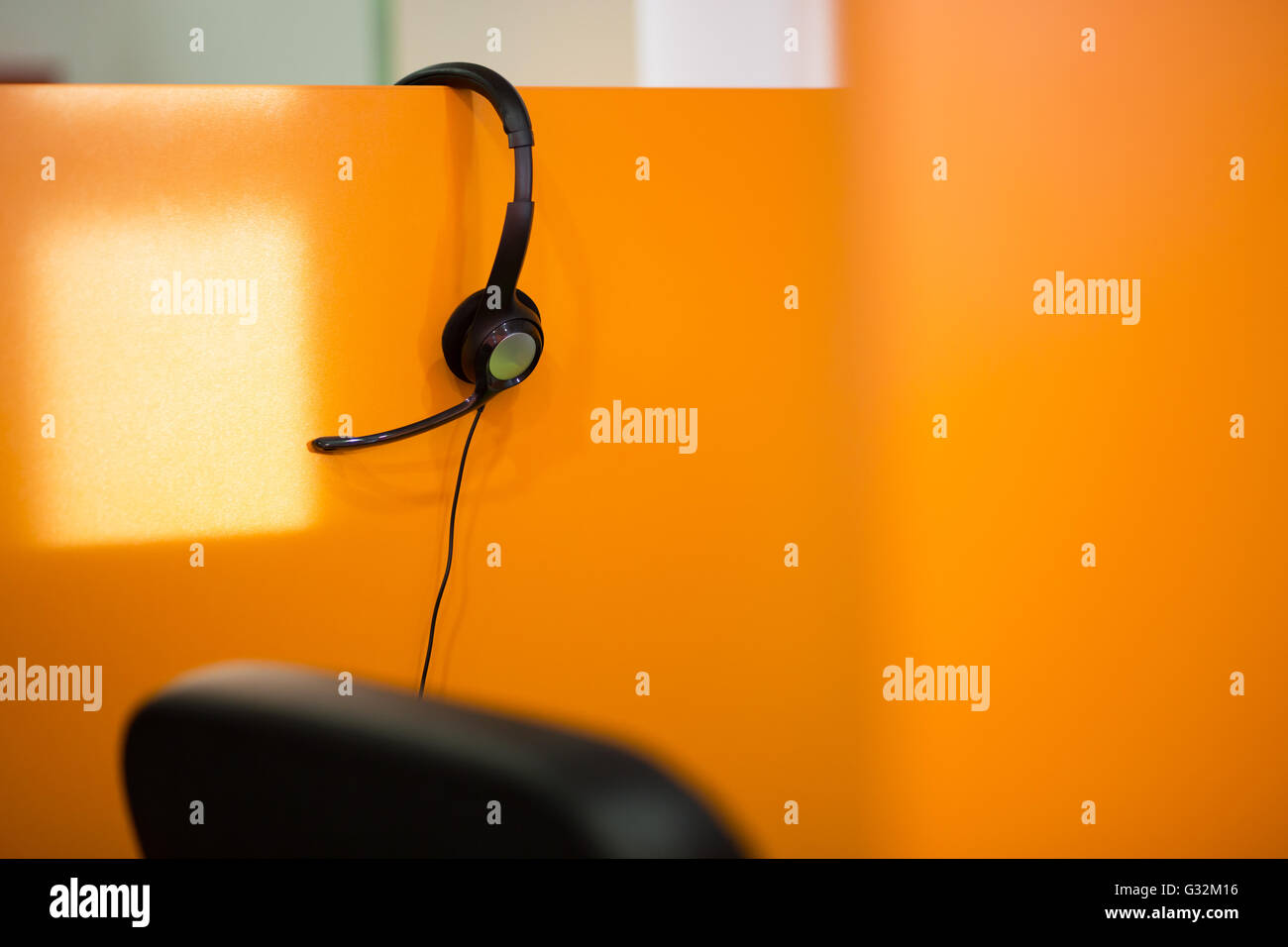 Headphones hanging on cubicle partition in empty office Stock Photo - Alamy