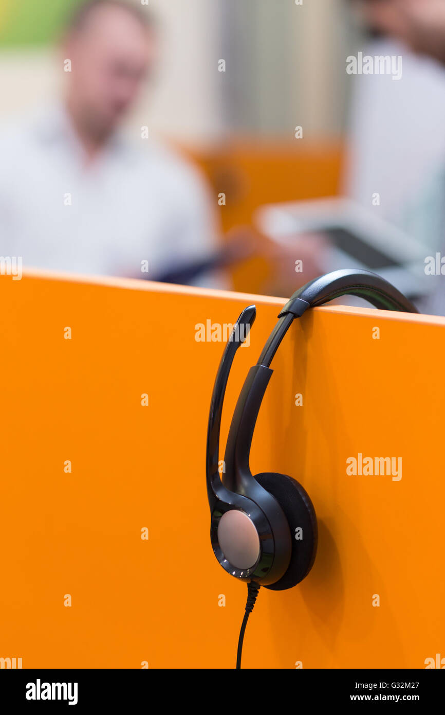 Headphones hanging on cubicle partition Stock Photo - Alamy
