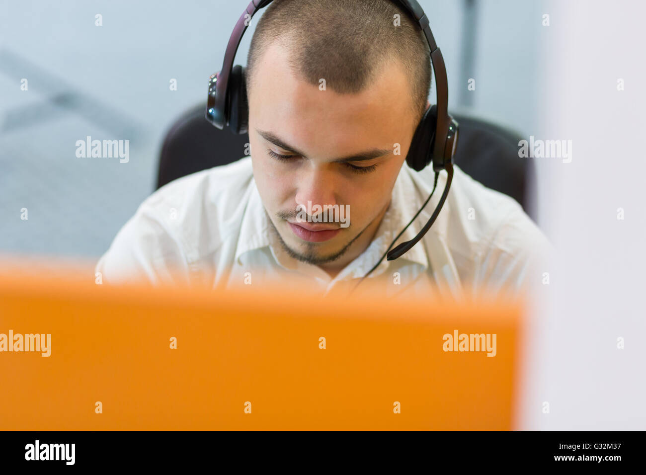 Portrait of confident male customer service representative with headset ...