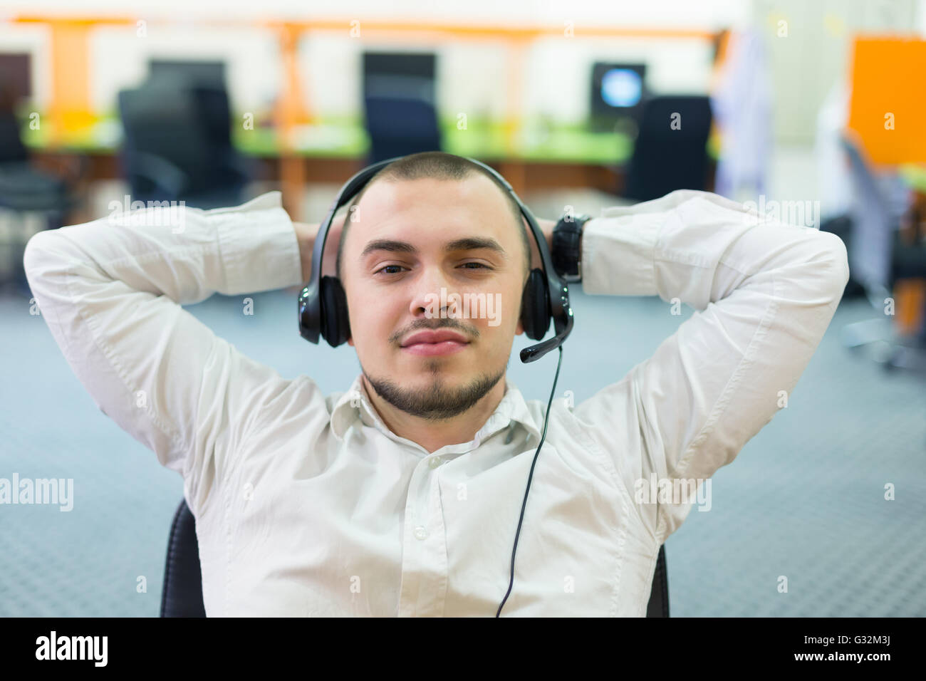 Satisfied with work done. Happy young man working on computer while ...