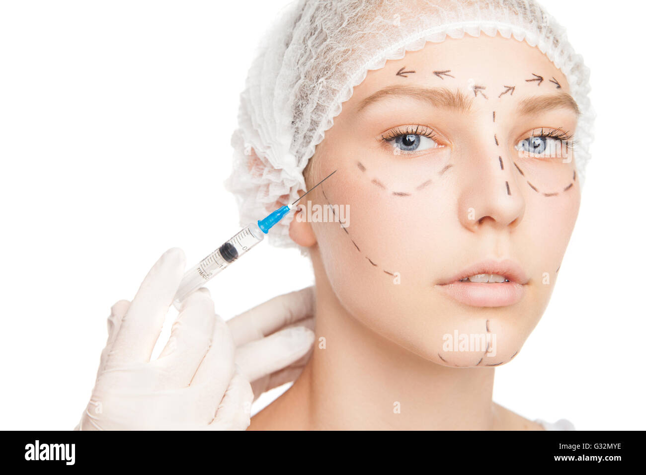 Surgeon injecting woman's face with outlines Stock Photo - Alamy