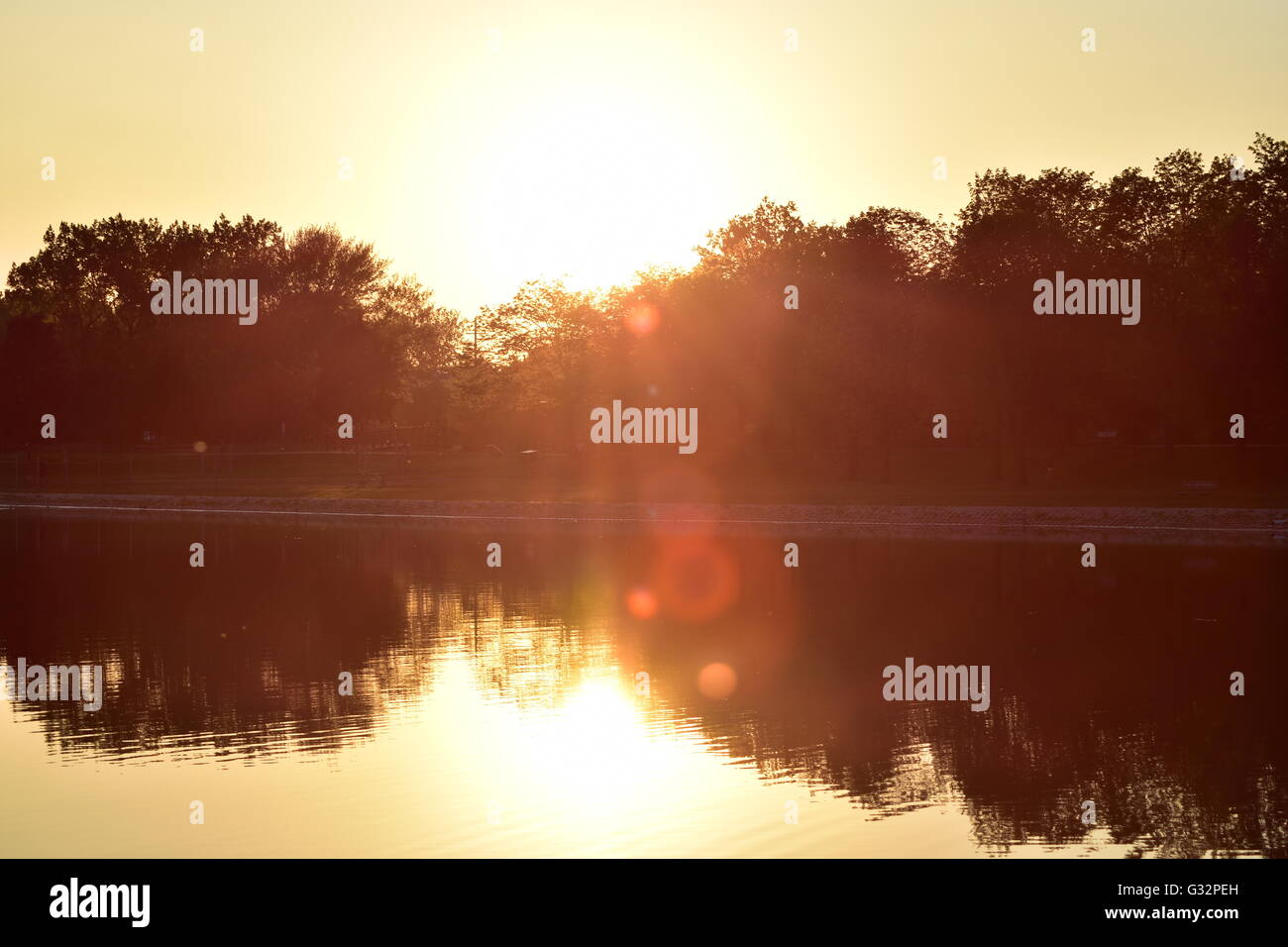 Sunset reflection on waters Stock Photo - Alamy