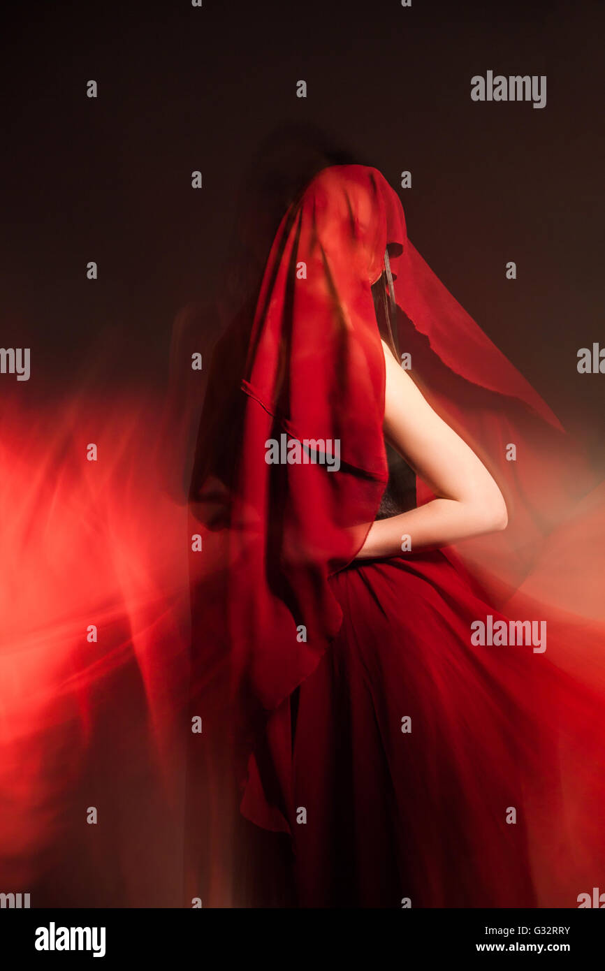Unrecognizable woman covered with red cloth Stock Photo - Alamy