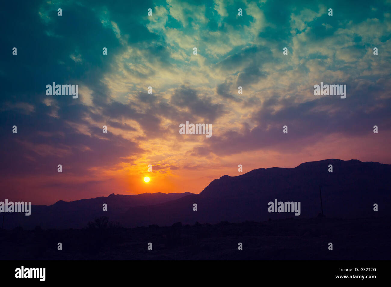 Sunset over desert Stock Photo - Alamy