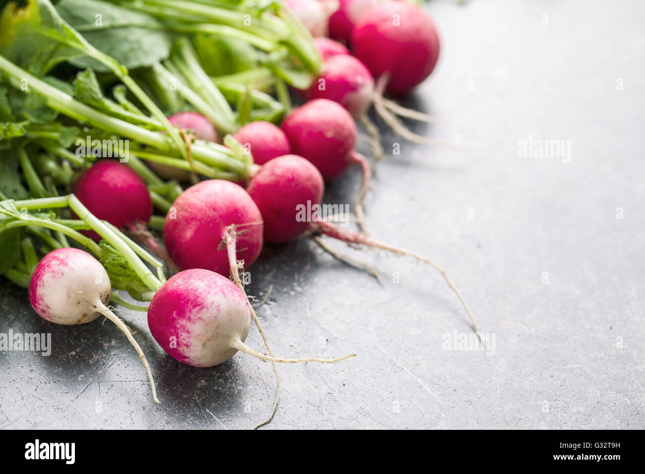 Fresh radishes on old kitchen table. Healthy vegetable Stock Photo - Alamy